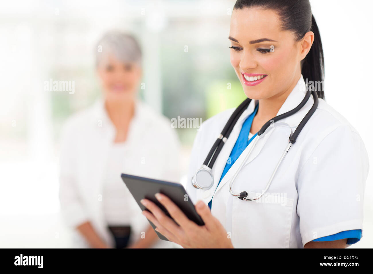 beautiful female health care worker using tablet computer in hospital ...