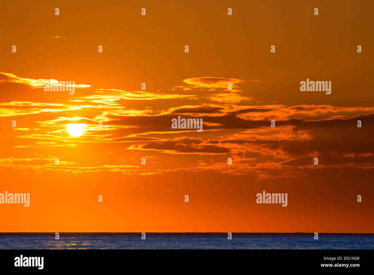 Sunset orange sky background at evening over sea with clouds Stock ...
