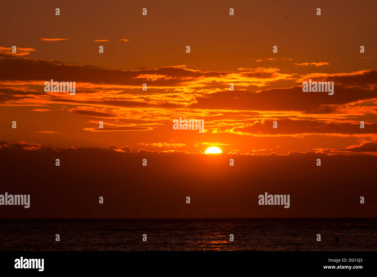 Sunset orange sky background at evening over sea with clouds Stock ...