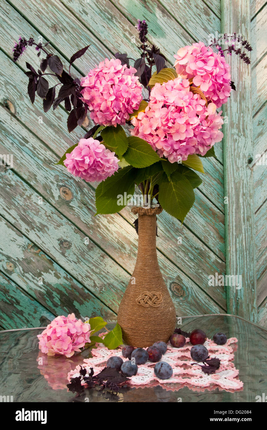 pink hydrangea and violet basil bouquet in a vintage vase still life ...