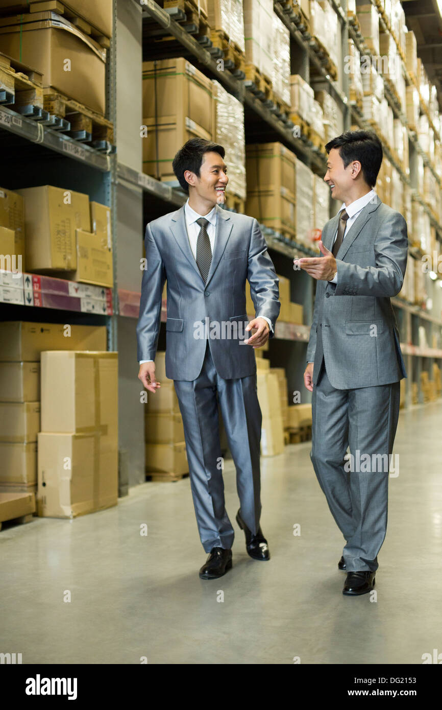 Business partners talking in logistic warehouse Stock Photo - Alamy