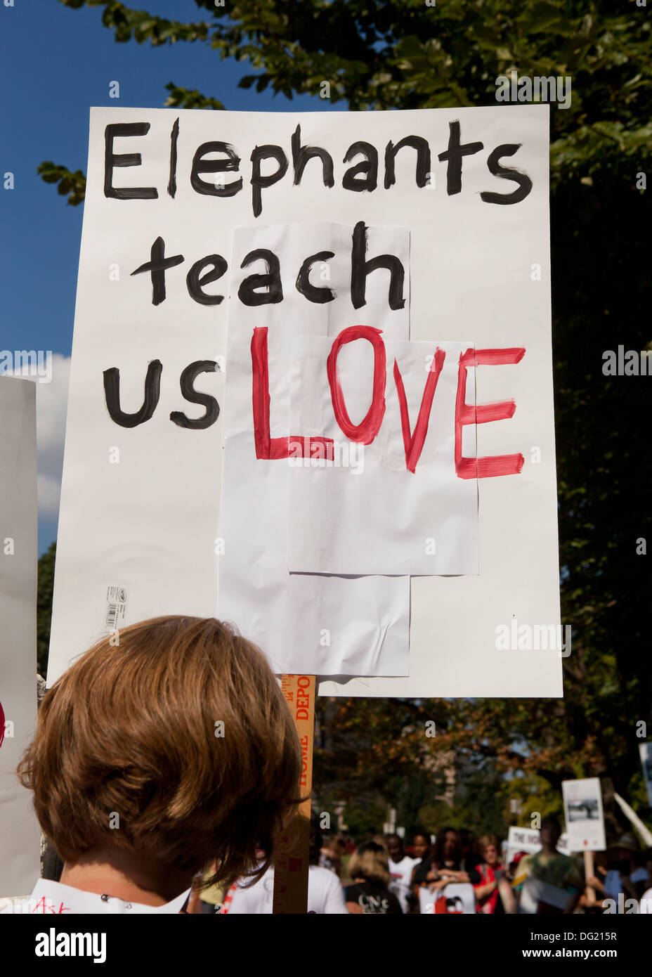 Elephant March demonstrator holding up sign protesting against poaching ...