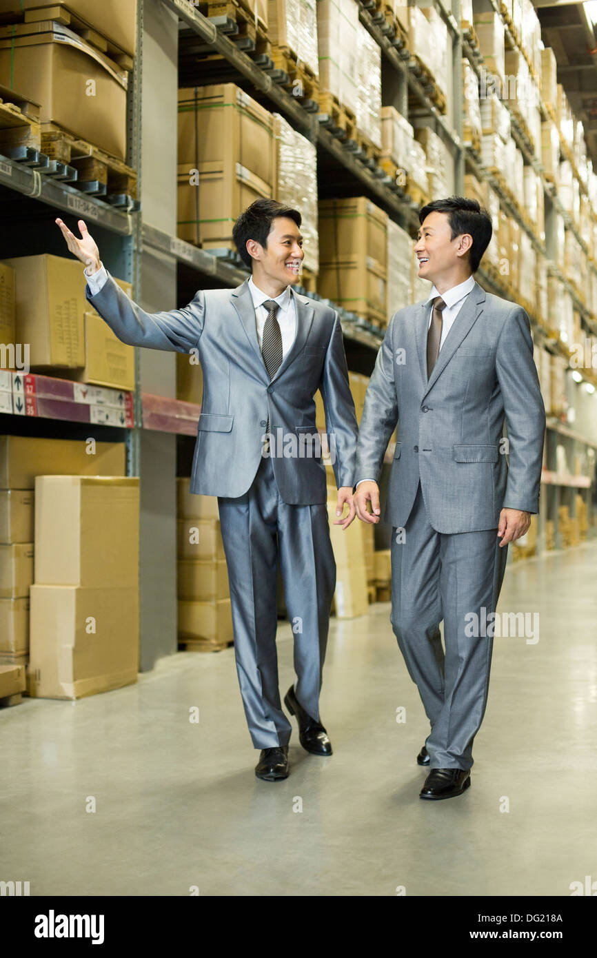 Business partners talking in logistic warehouse Stock Photo - Alamy