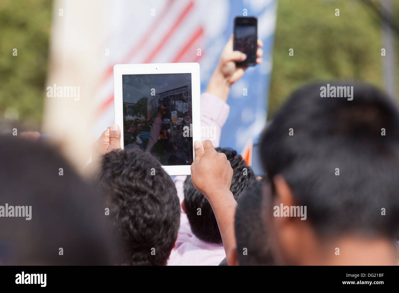 Man video taping with iPad at outdoor event - USA Stock Photo - Alamy
