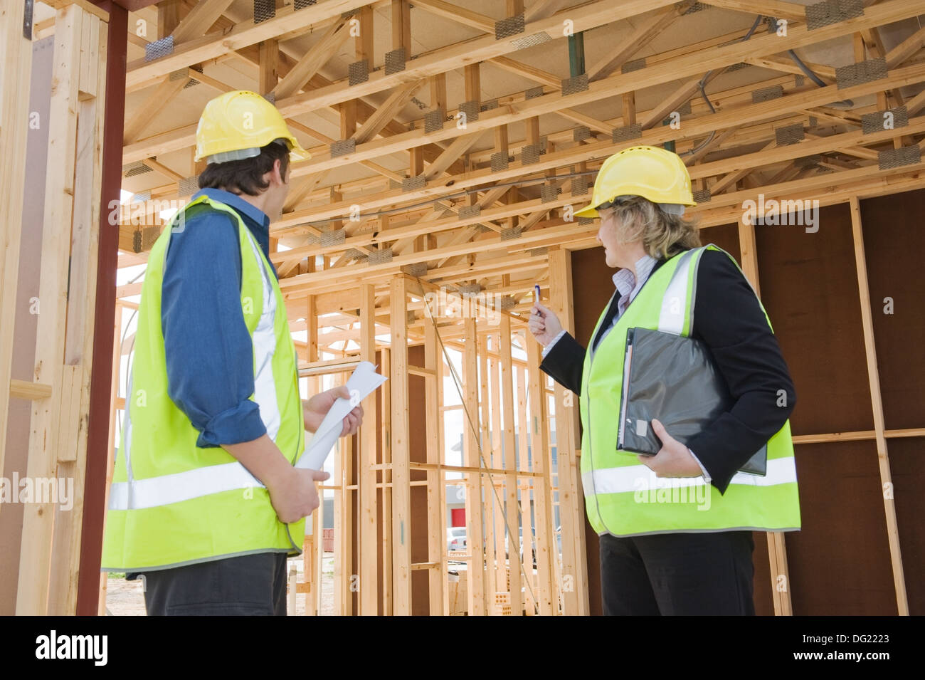 Civil engineer and worker discussing issues at the construction site ...