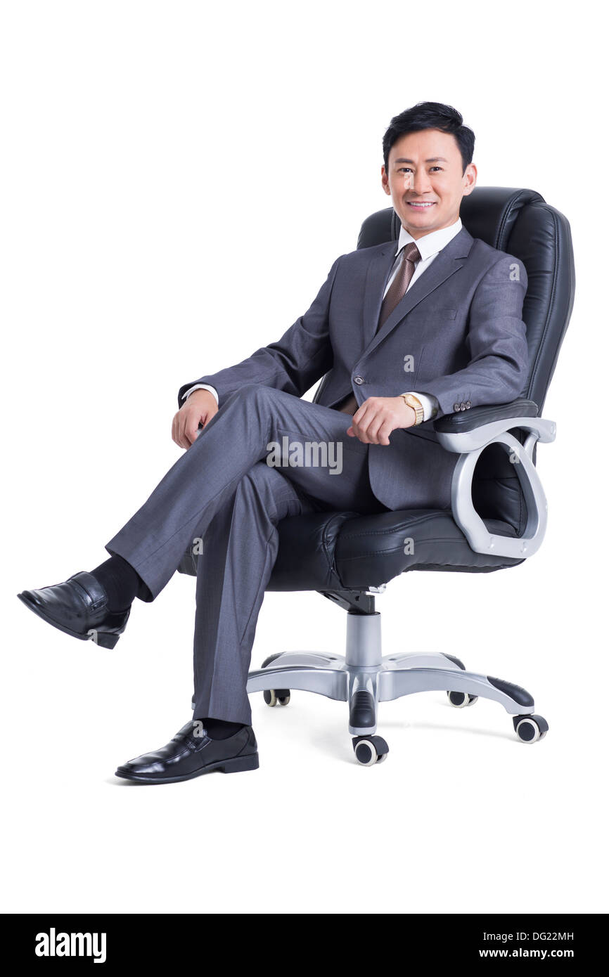 Mature manager sitting in chair Stock Photo - Alamy