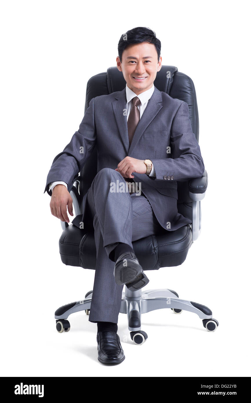 Mature manager sitting in chair Stock Photo - Alamy