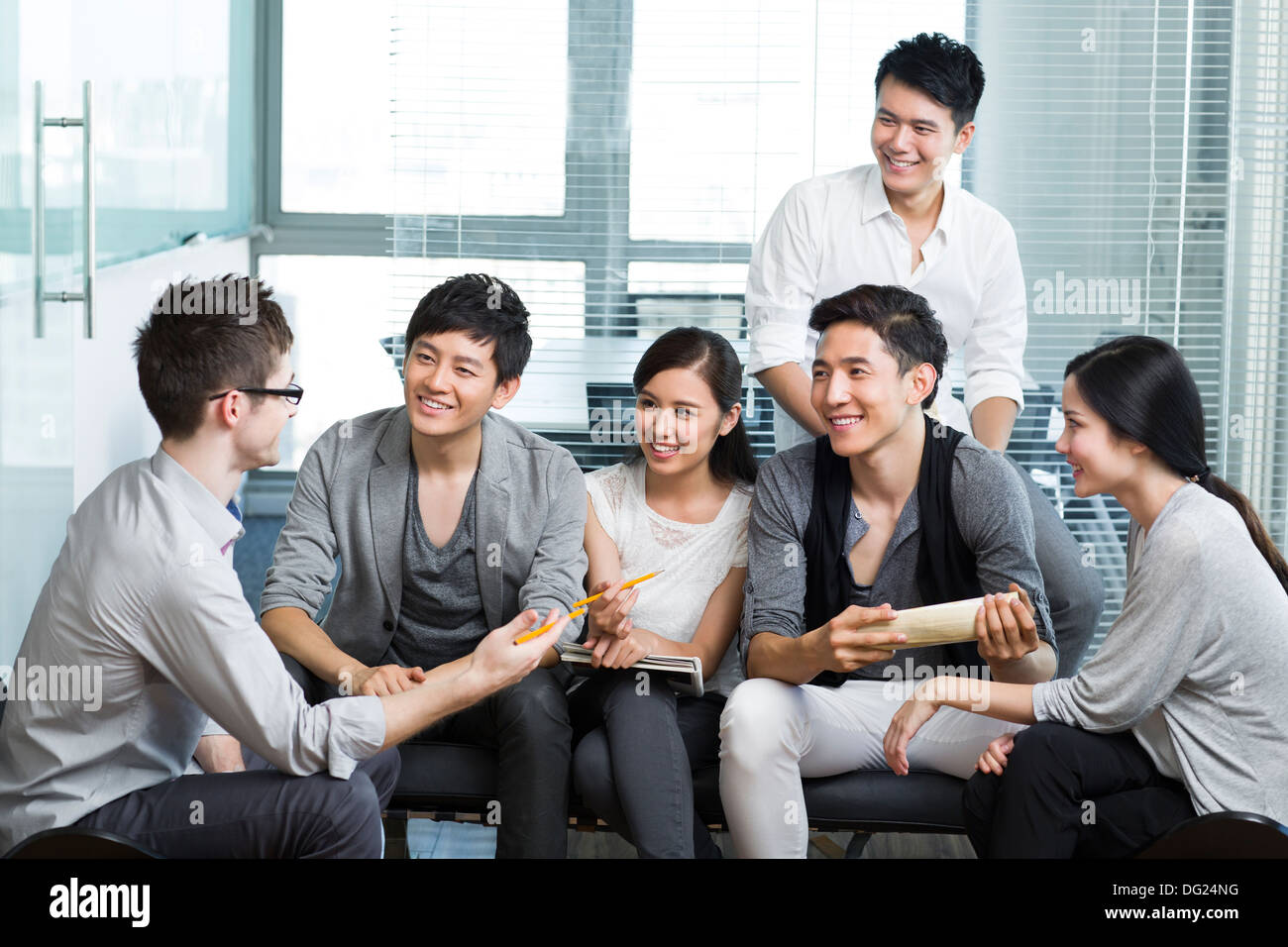 Young office workers holding a meeting Stock Photo - Alamy