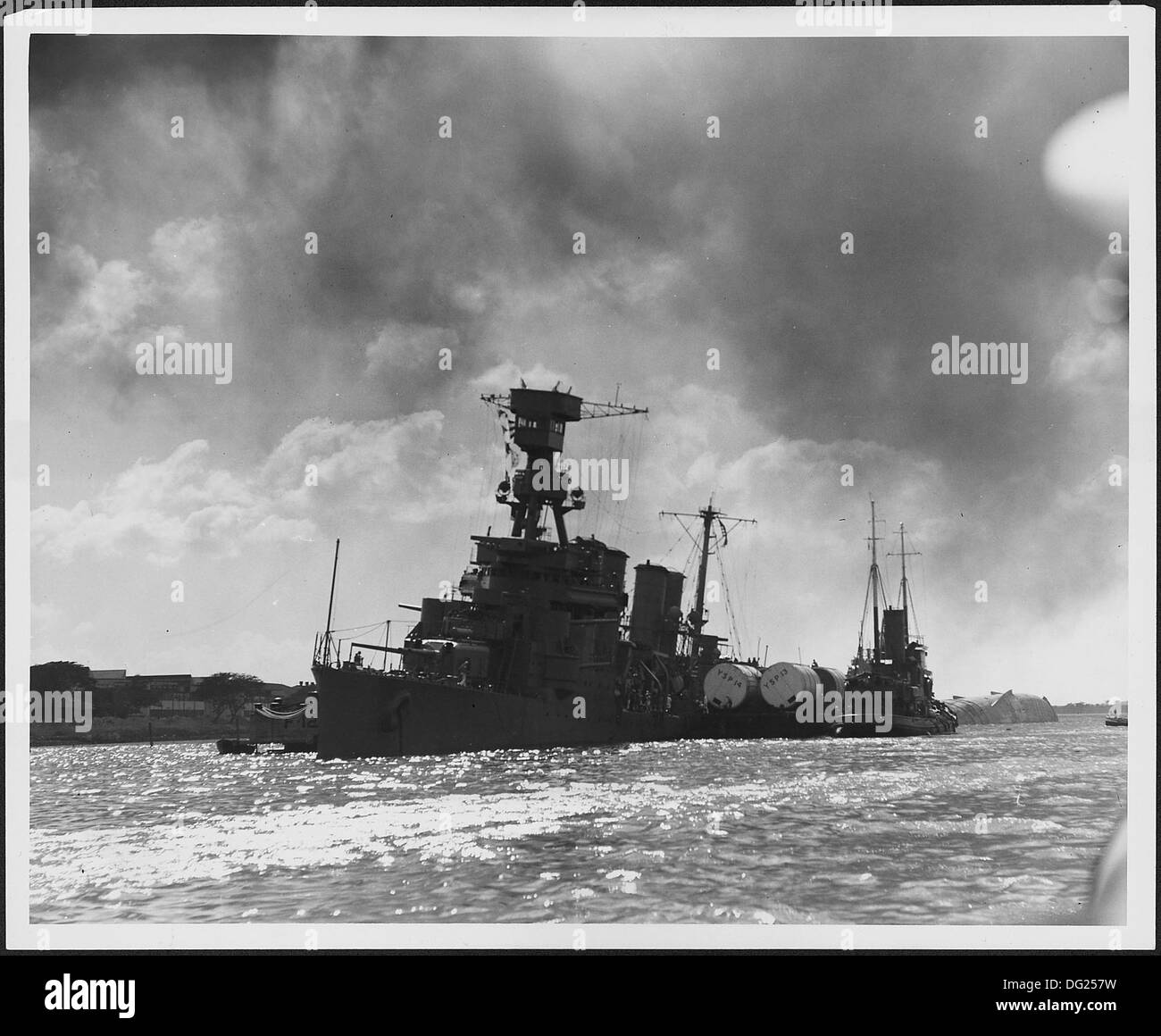 The USS Raleigh, an important naval ship, is shown being held afloat ...