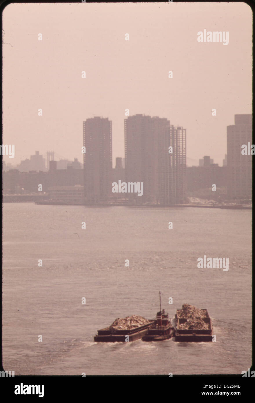 A tugboat tows garbage scows down the East River, with the final ...