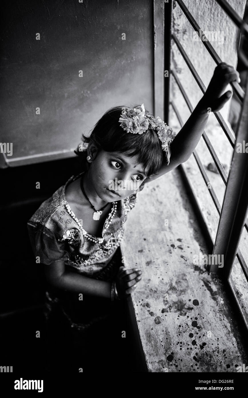 Young Indian girl standing at a school room window day dreaming Andhra ...