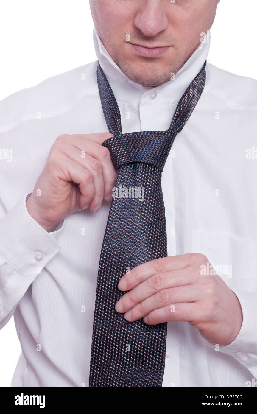 A man is tying a tie with his hands Stock Photo - Alamy