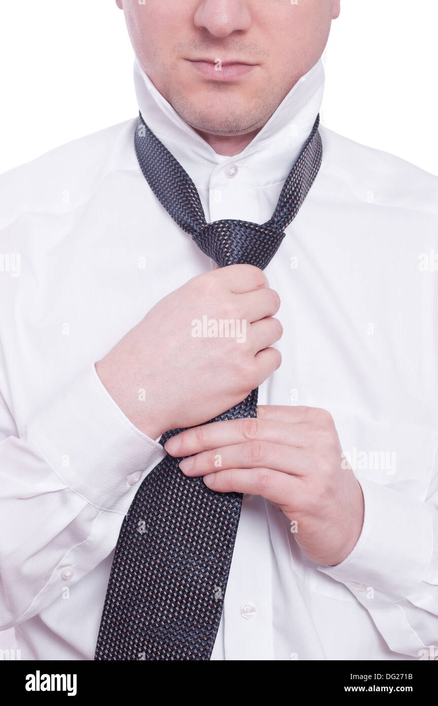 A man is tying a tie with his hands Stock Photo - Alamy