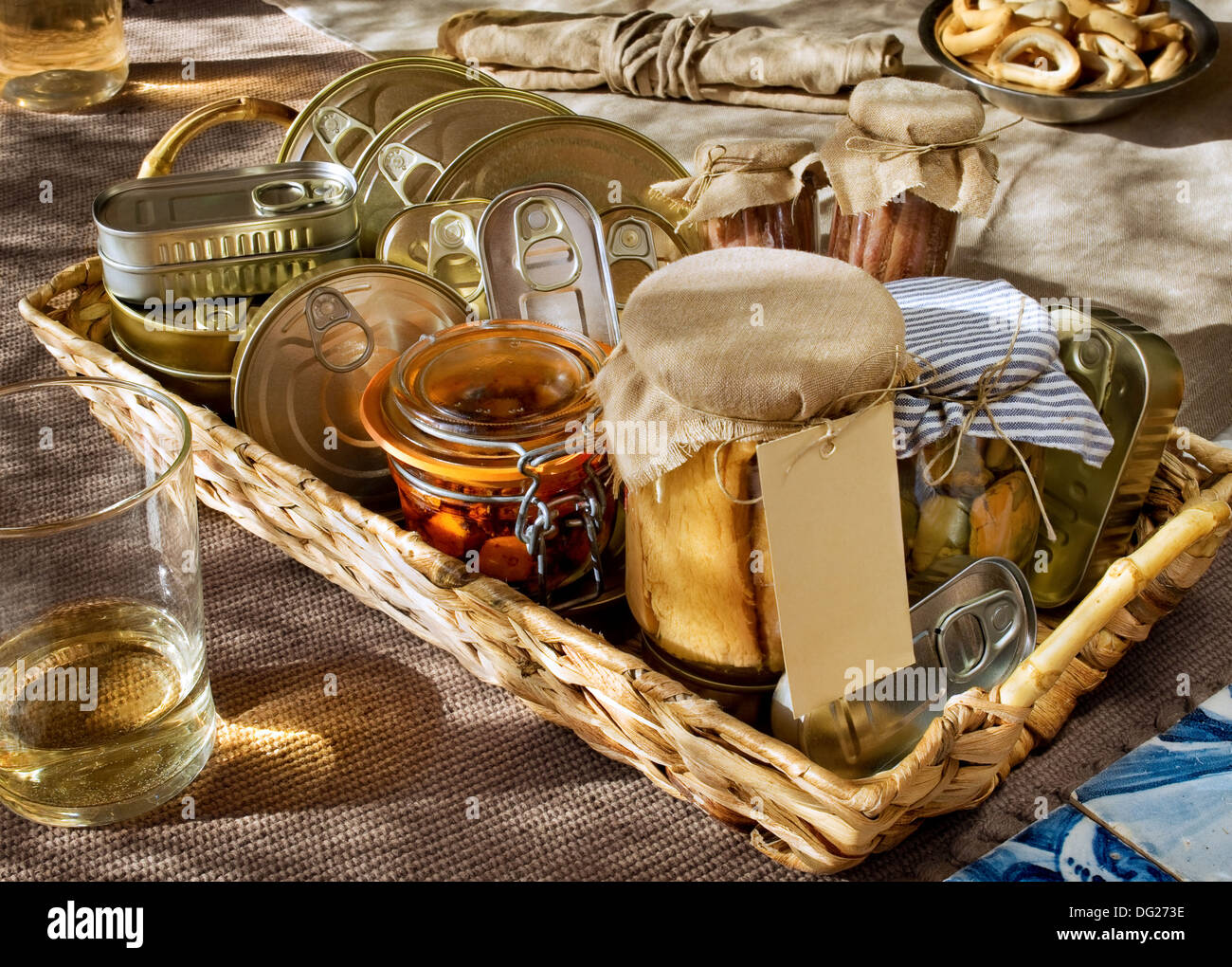A selection of canned fish with a blank label at a rustic environment ...