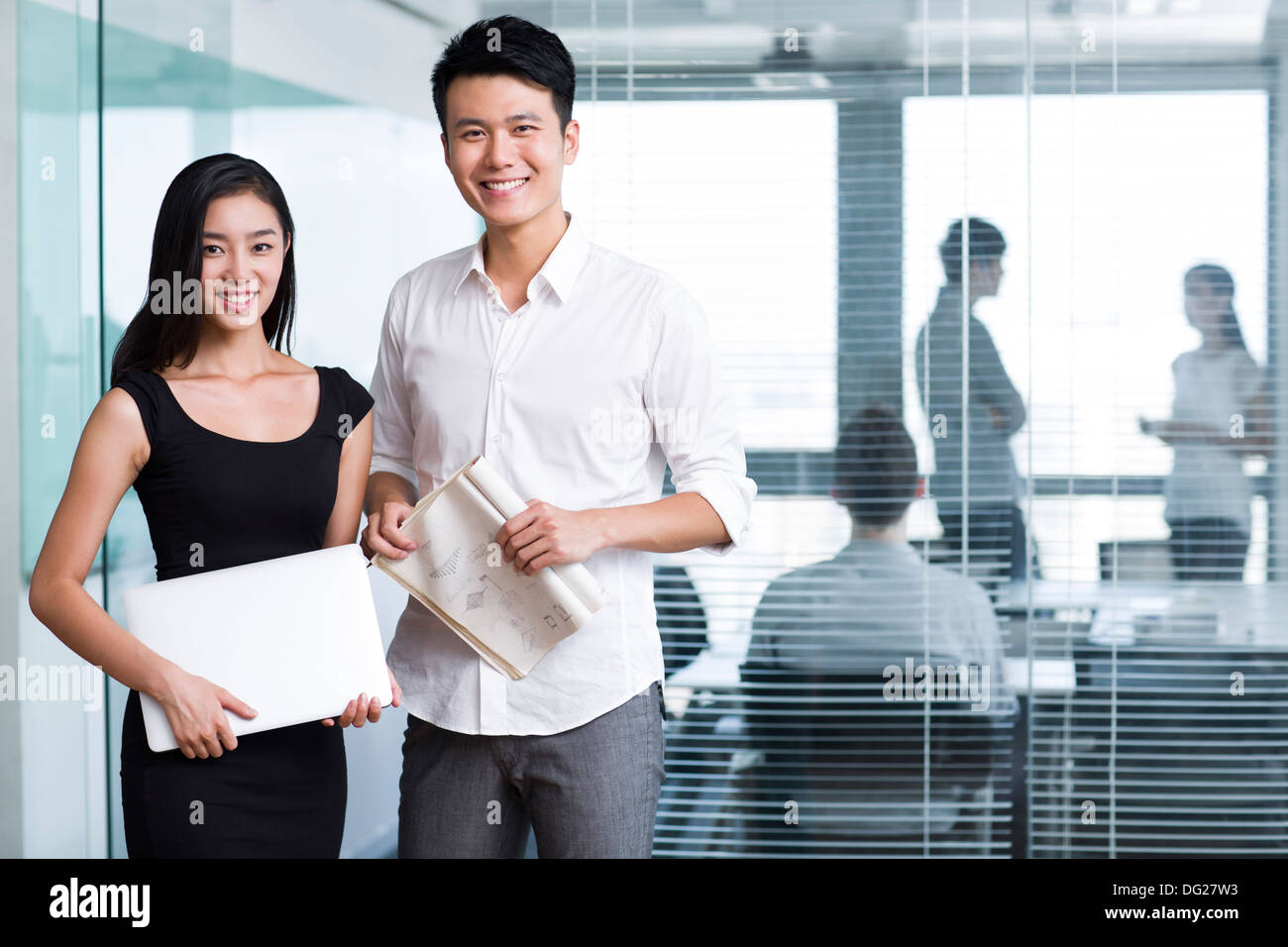 Happy business people with laptop Stock Photo - Alamy