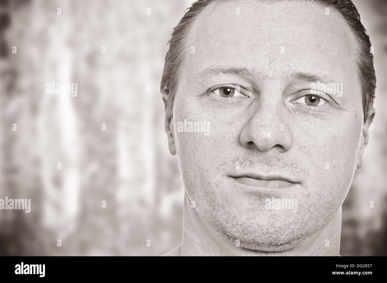 A black and white portrait from a man who is looking into the camera ...