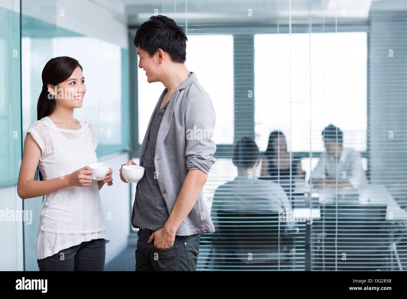 Happy office workers taking a coffee break Stock Photo - Alamy