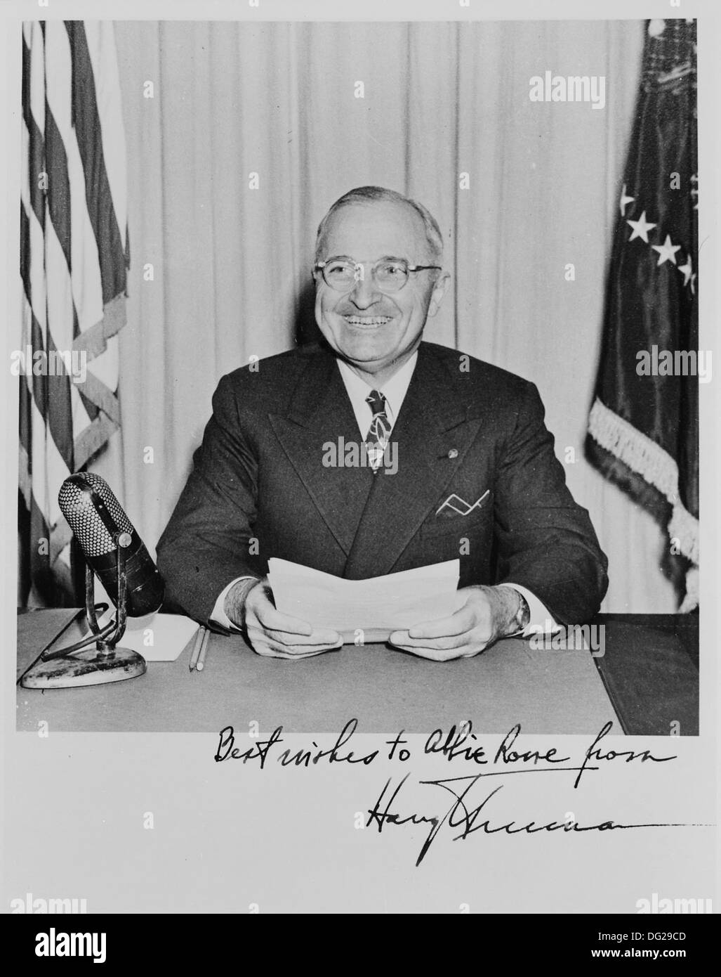 A photograph capturing President Truman smiling while addressing the ...