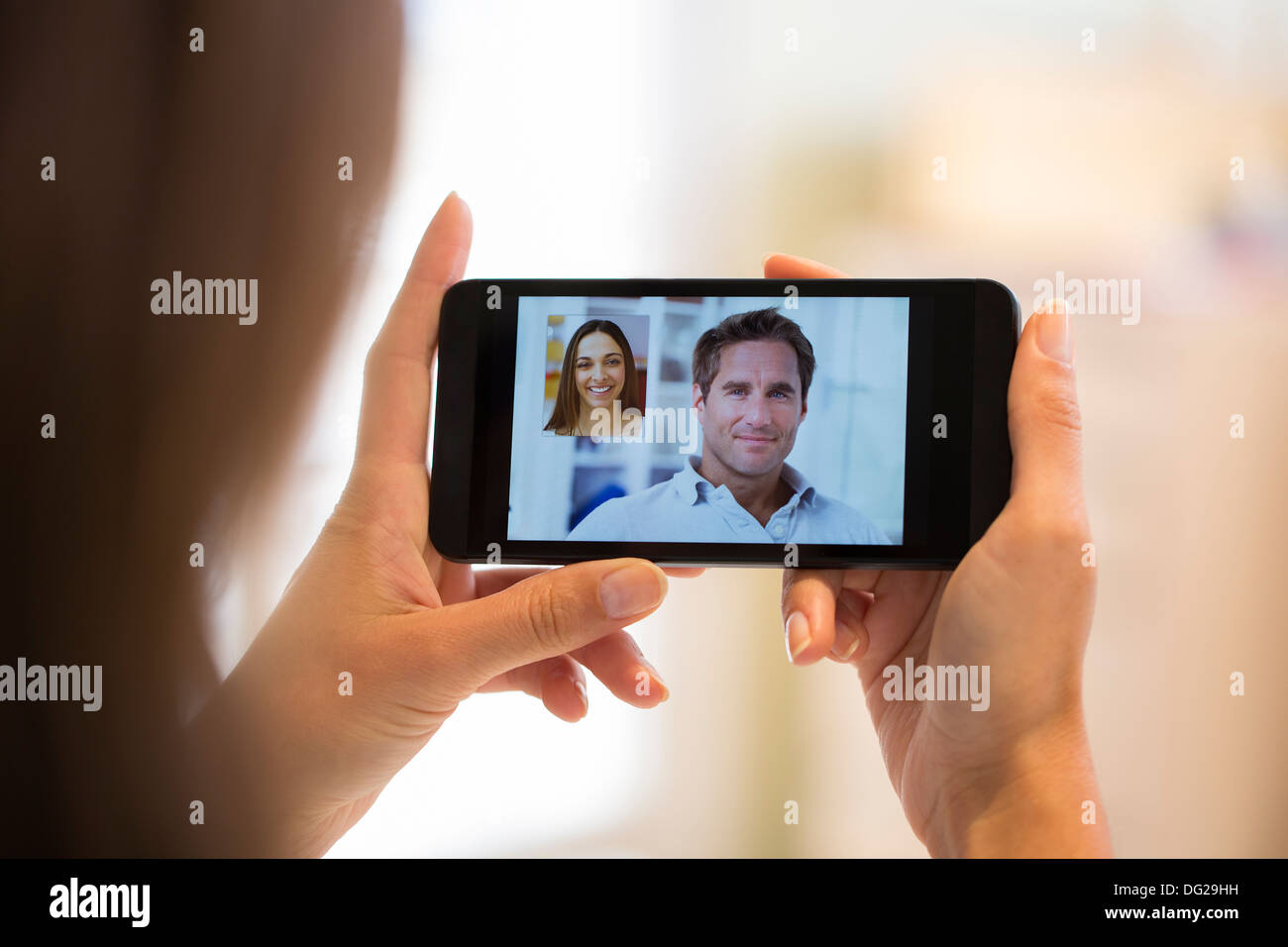 Woman chatting with her friend on smartphone Stock Photo - Alamy