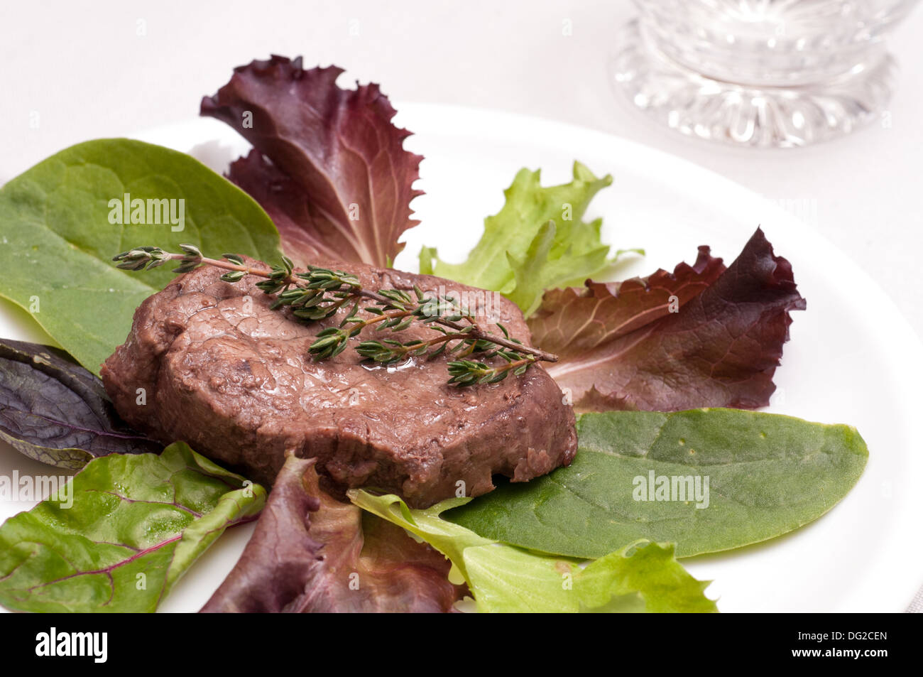 Fillet of beef with thyme on leaf salad Stock Photo - Alamy