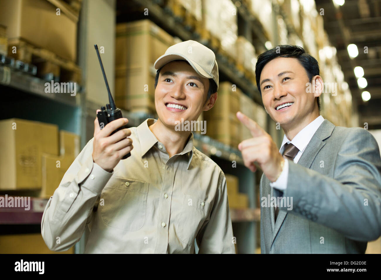 Young logistics staff with businessman Stock Photo - Alamy