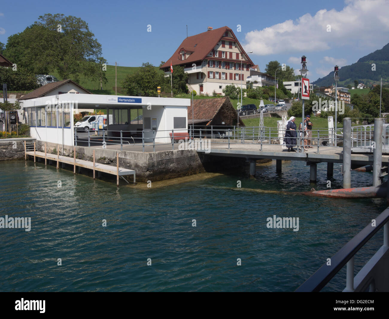 Arriving at the landing in Hertenstein on a passenger boat traveling ...