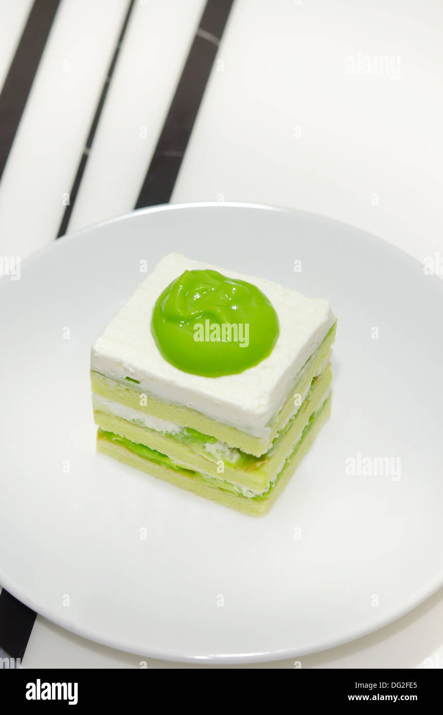 Pandan cake with white cream on dish Stock Photo - Alamy