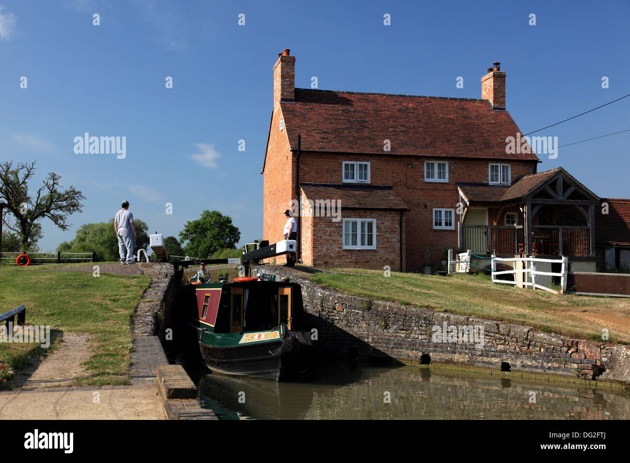 A narrowboat descending the bottom lock of the Napton flight of nine ...