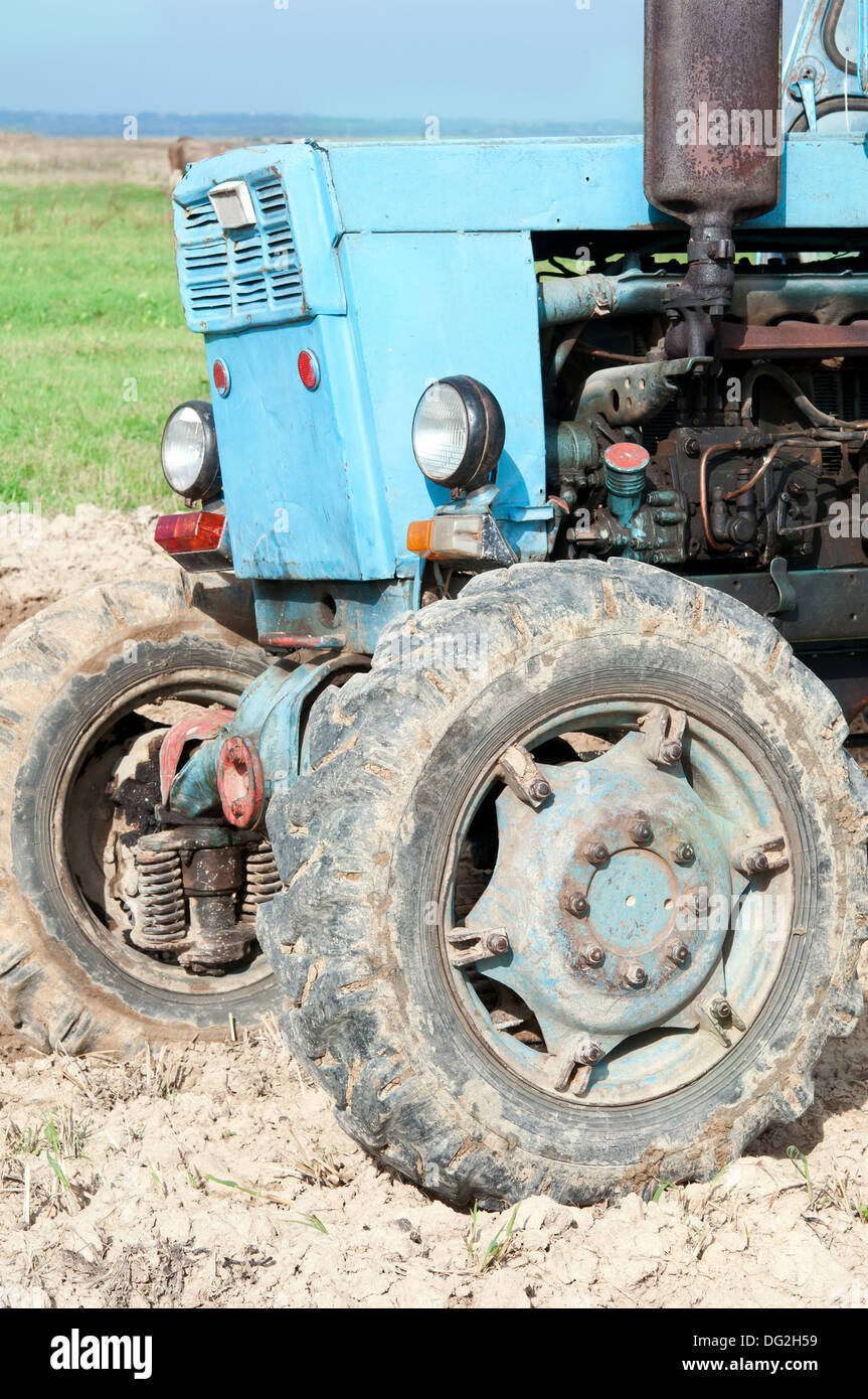 Old blue tractor on the field Stock Photo - Alamy