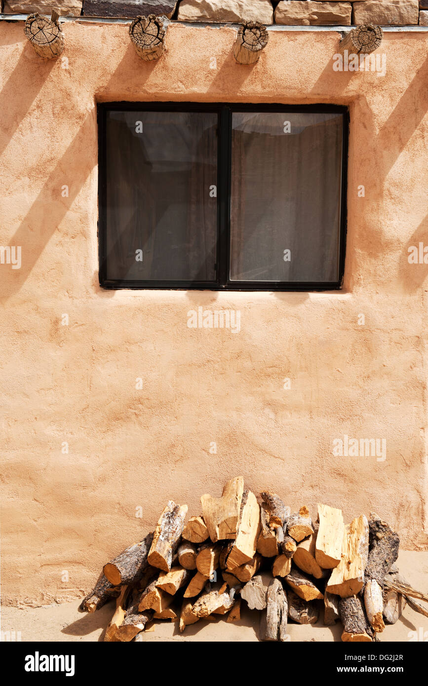 Window and Wood Pile in front of a building at a Pueblo in New Mexico ...