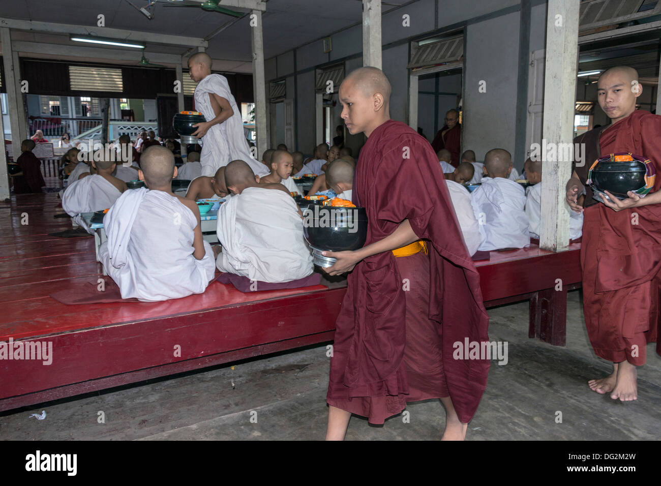 Red robed older monks carrying bowls of rice hi-res stock photography ...