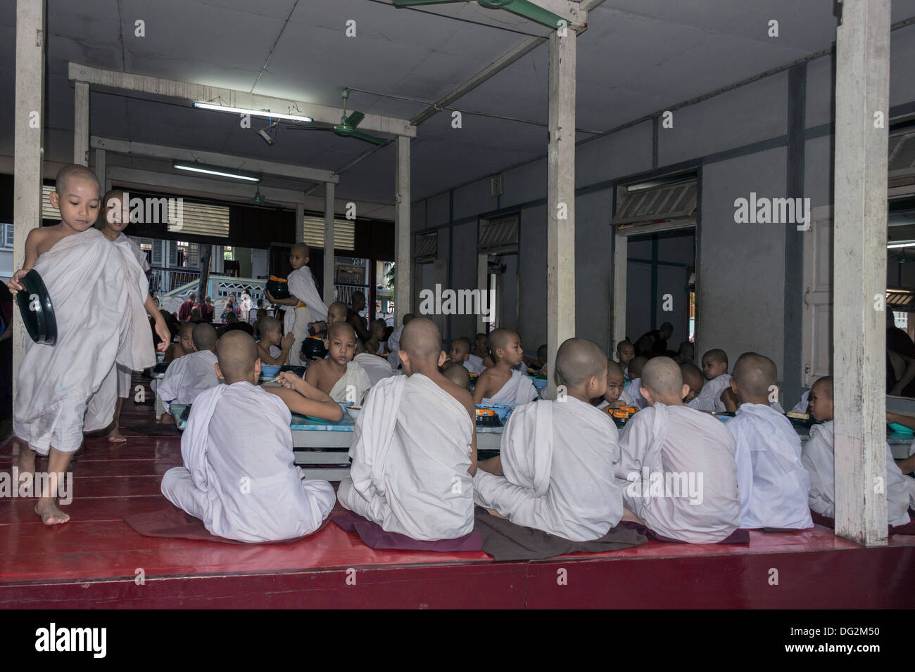 Novice monks eating their midday meal in the dining hall, Mahagandayon ...