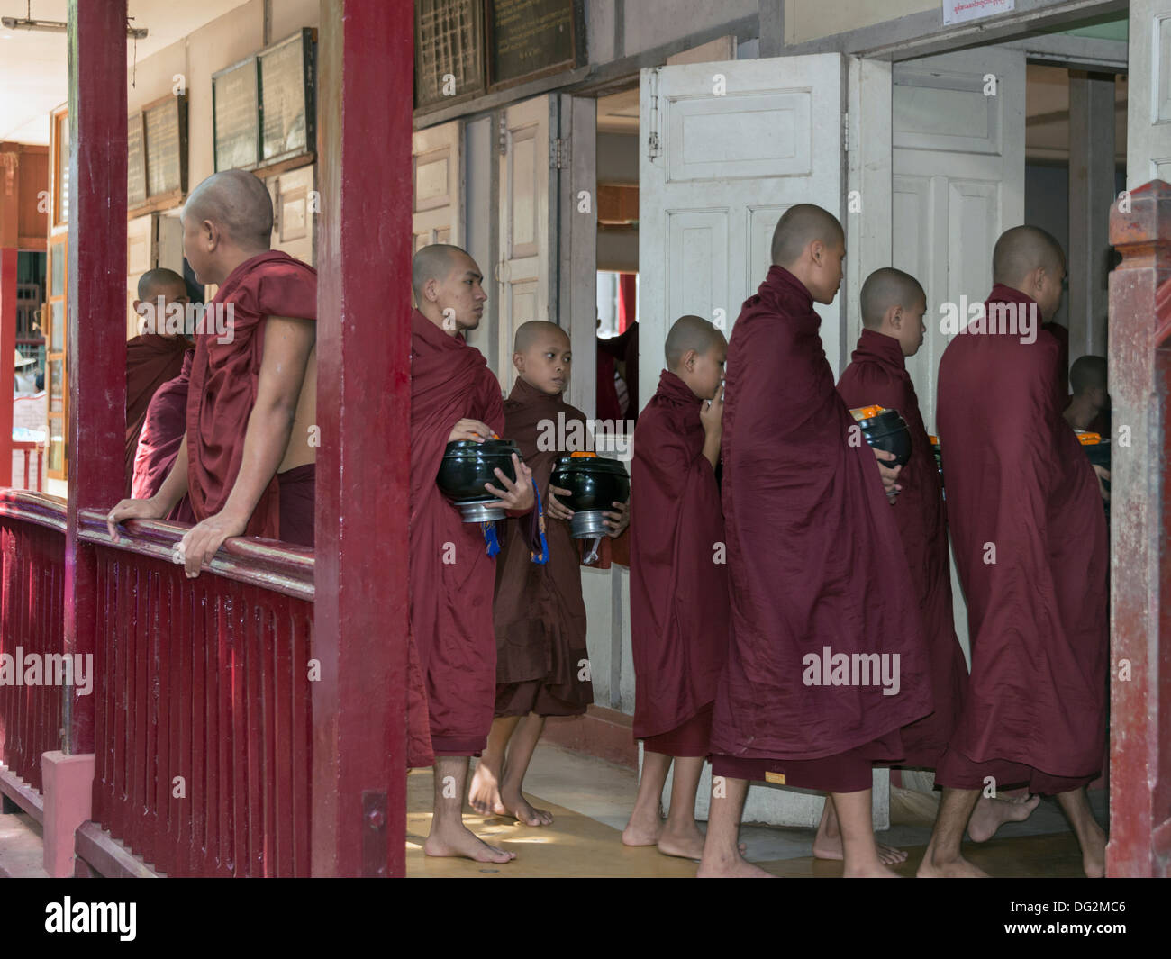 Monks taking their midday meal into the dining hall, Mahagandayon ...