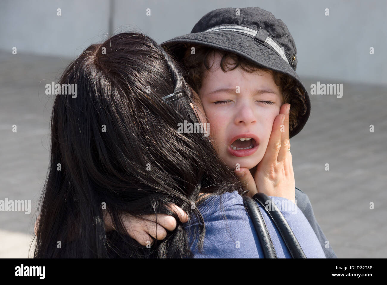 Mom calms weeping children Stock Photo - Alamy