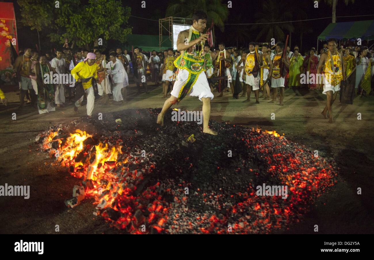 Phuket, Thailand. 13th Oct, 2013. Devotees walk across hot coals at the ...