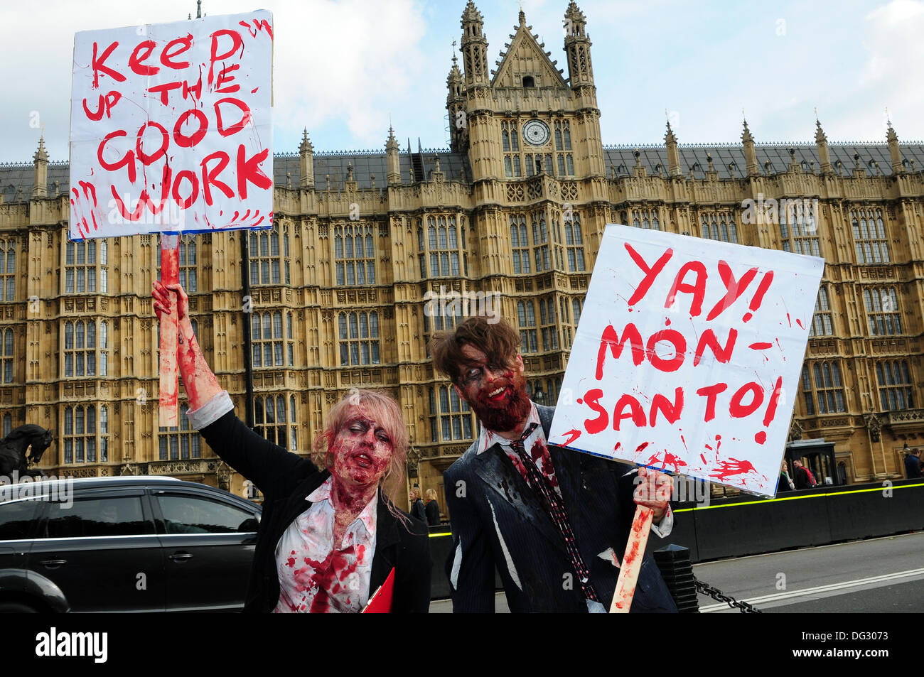 London UK, 12th Oct 2013 : Two Zombie join protesters holding a placard ...