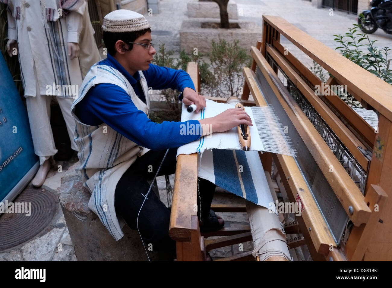 A young Israeli boy knitting a Talit Jewish prayer shawl in the Jewish ...