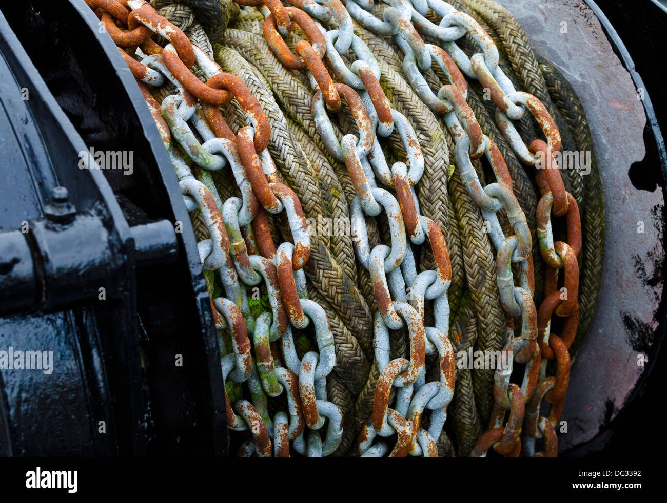 Wound up rope and rusty chains on a boat Stock Photo - Alamy