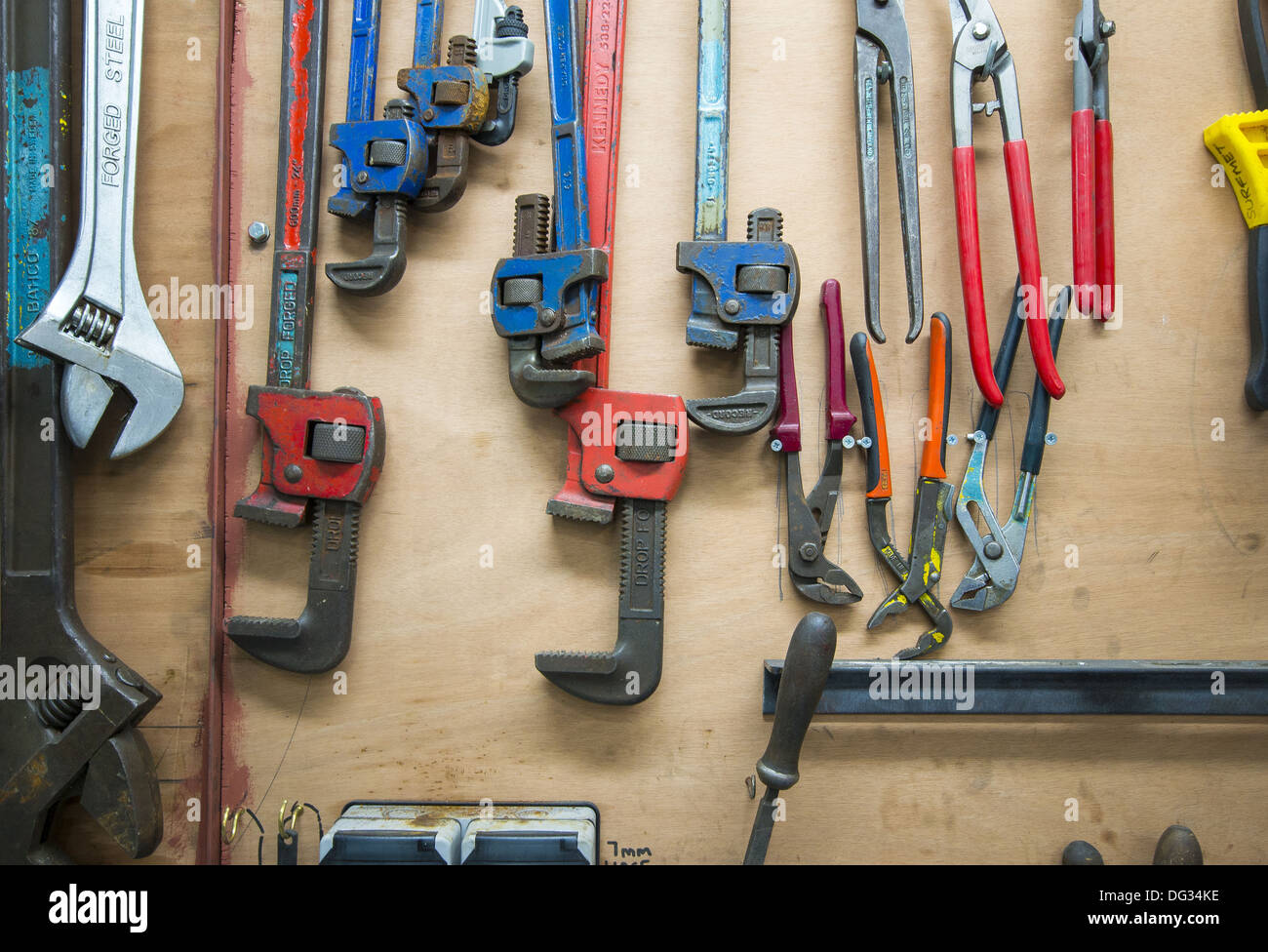 A selection of tools hanging in workshop Stock Photo - Alamy