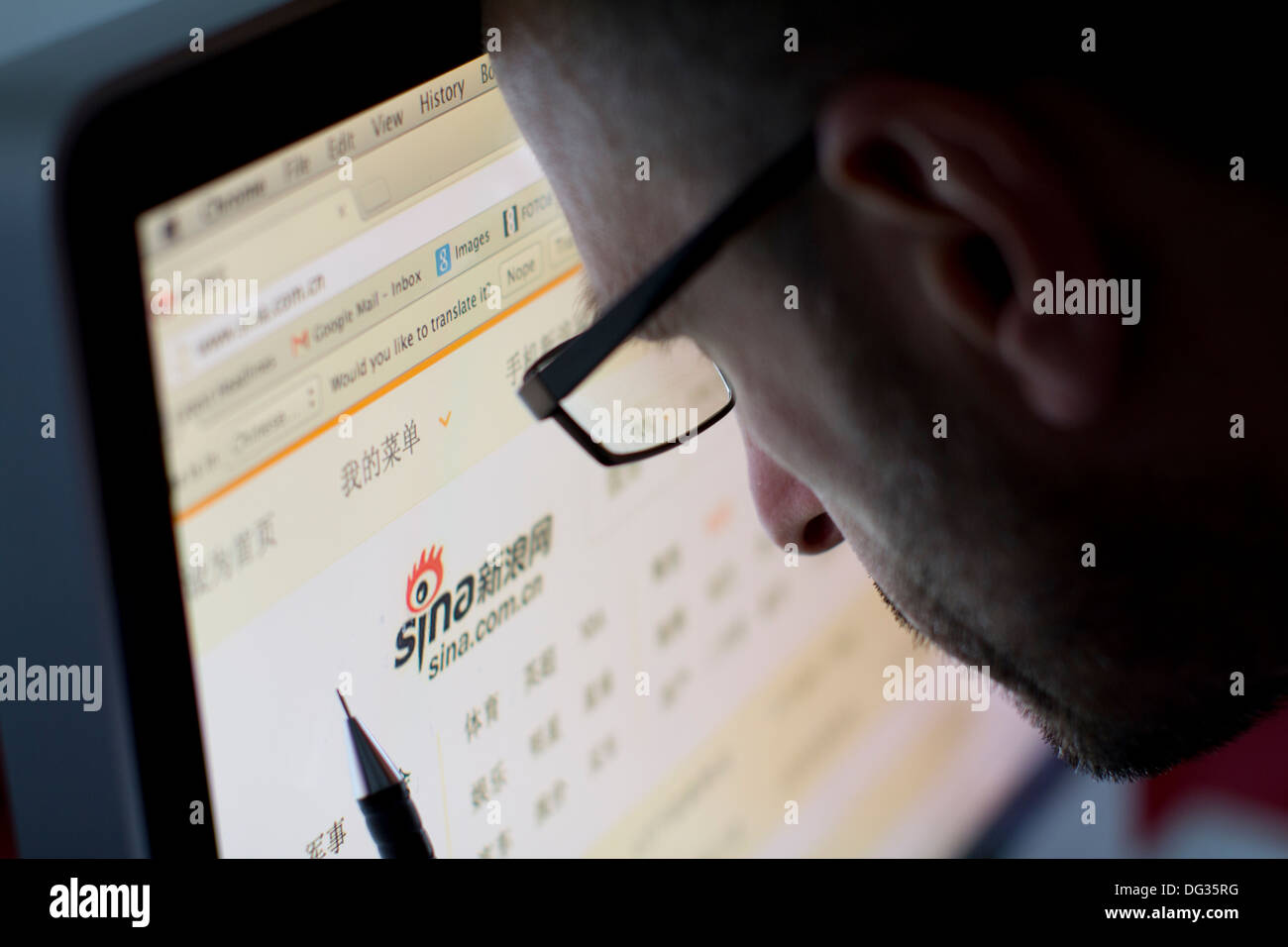 Adult male looking at the online internet website of sina, Sina is a ...