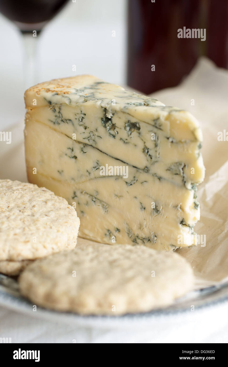 Stilton cheese on aged parchment paper with oat biscuits. Selective ...