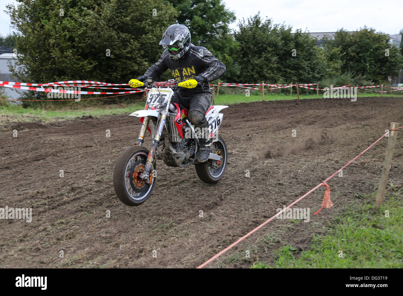 Supermoto rider accelerating on mud track. Focused on the rider Stock ...