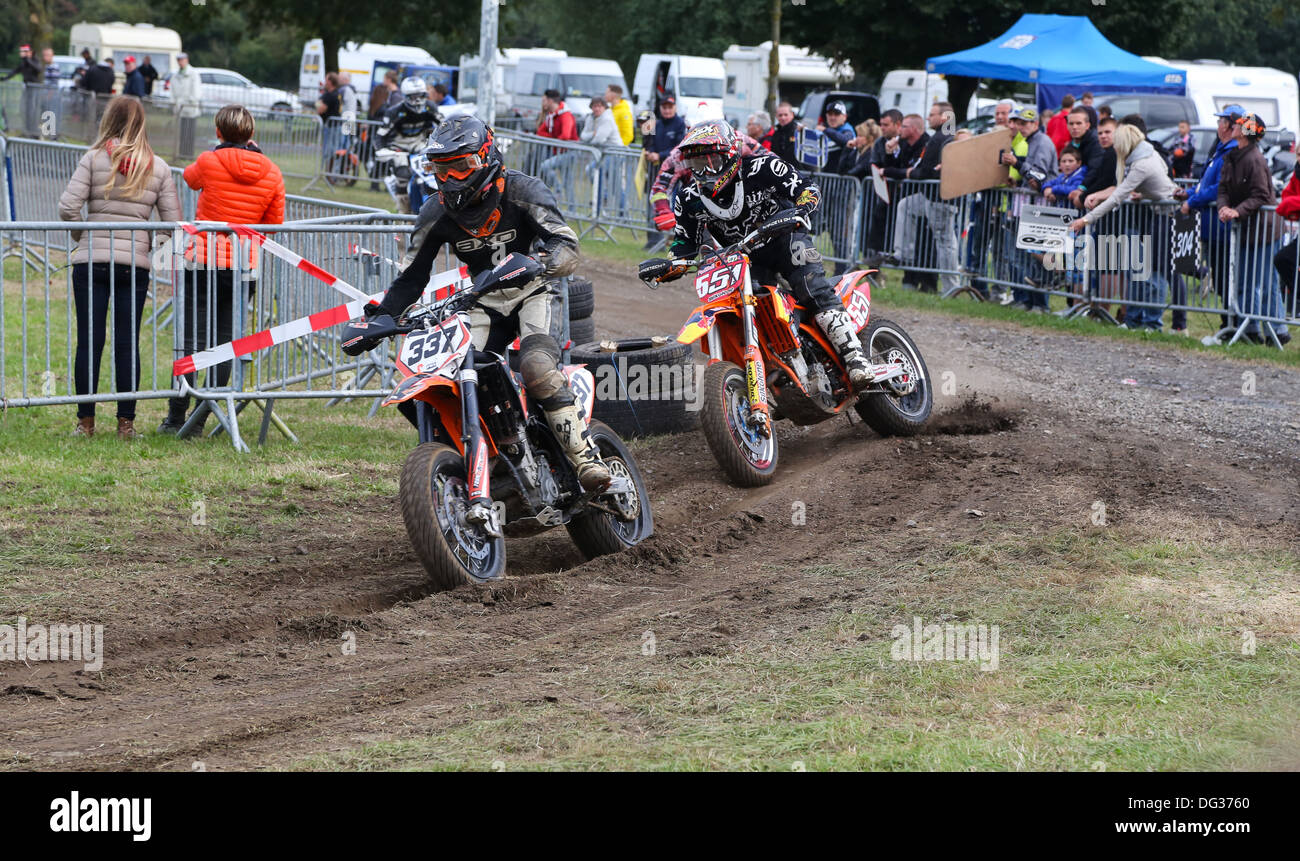 Supermoto riders taking a curve on the dirt track. Focused on the rider ...