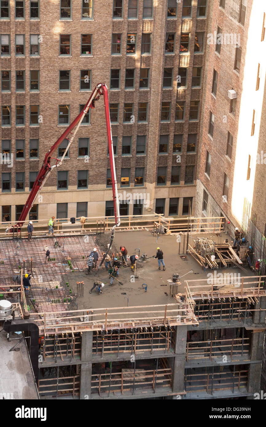 High-rise Building Construction Site with tradesmen Stock Photo - Alamy