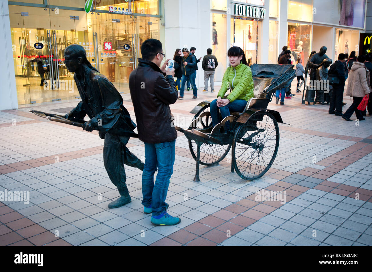 depicting figures of Chinese rickshaw man at Wangfujing pedestrian ...