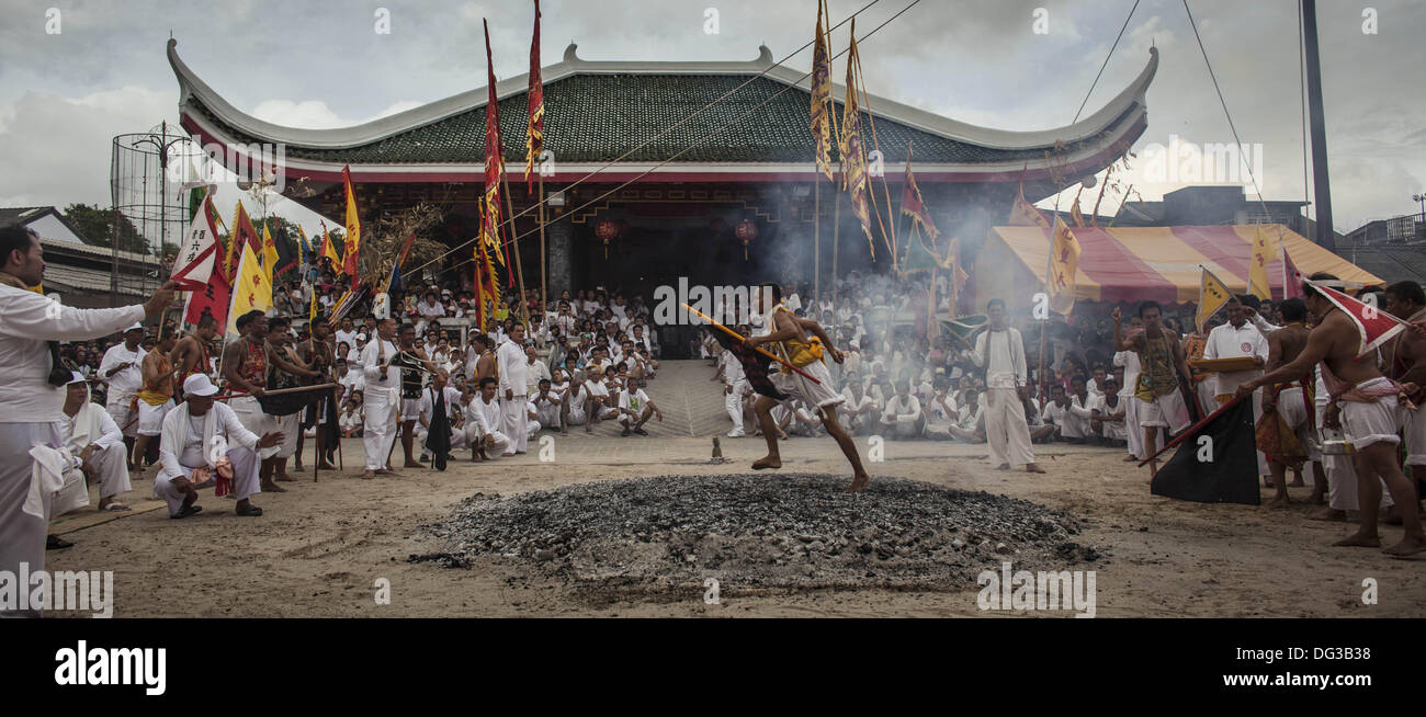 Phuket, Thailand. 13th Oct, 2013. Devotees to the Chinese shrine of Kathu participate in fire ...