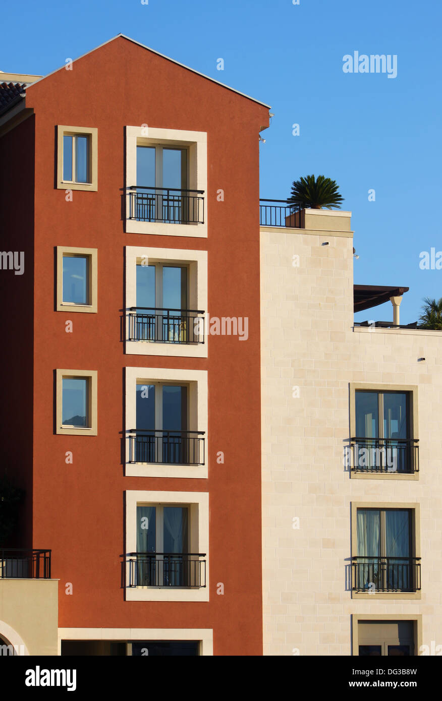 Red and white modern residental building with blue sky Stock Photo - Alamy