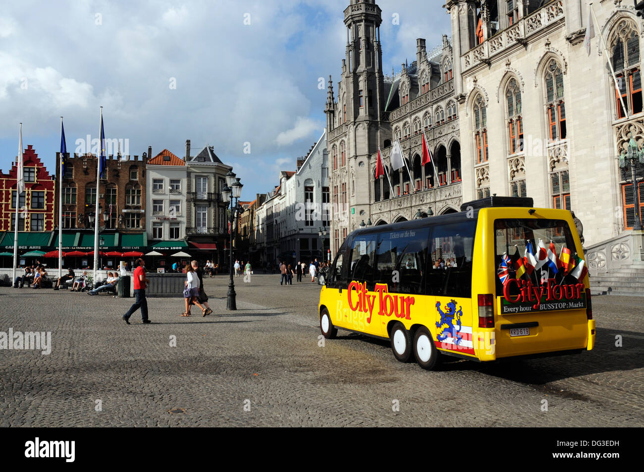 A tourist city tour bus in the Market Square (Markt) Bruges, Belgium ...