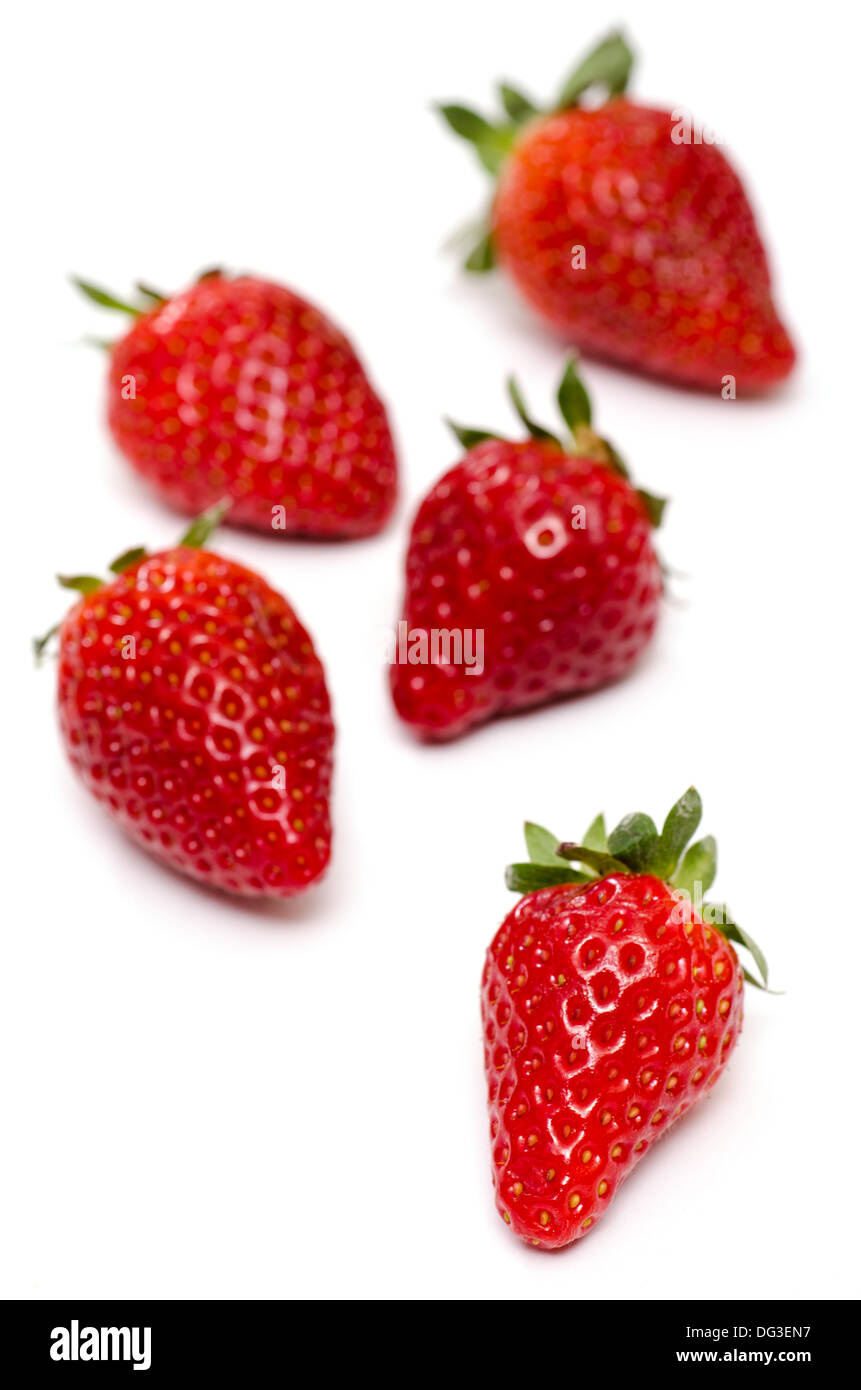 Five red strawberries on a white background in vertical format Stock ...