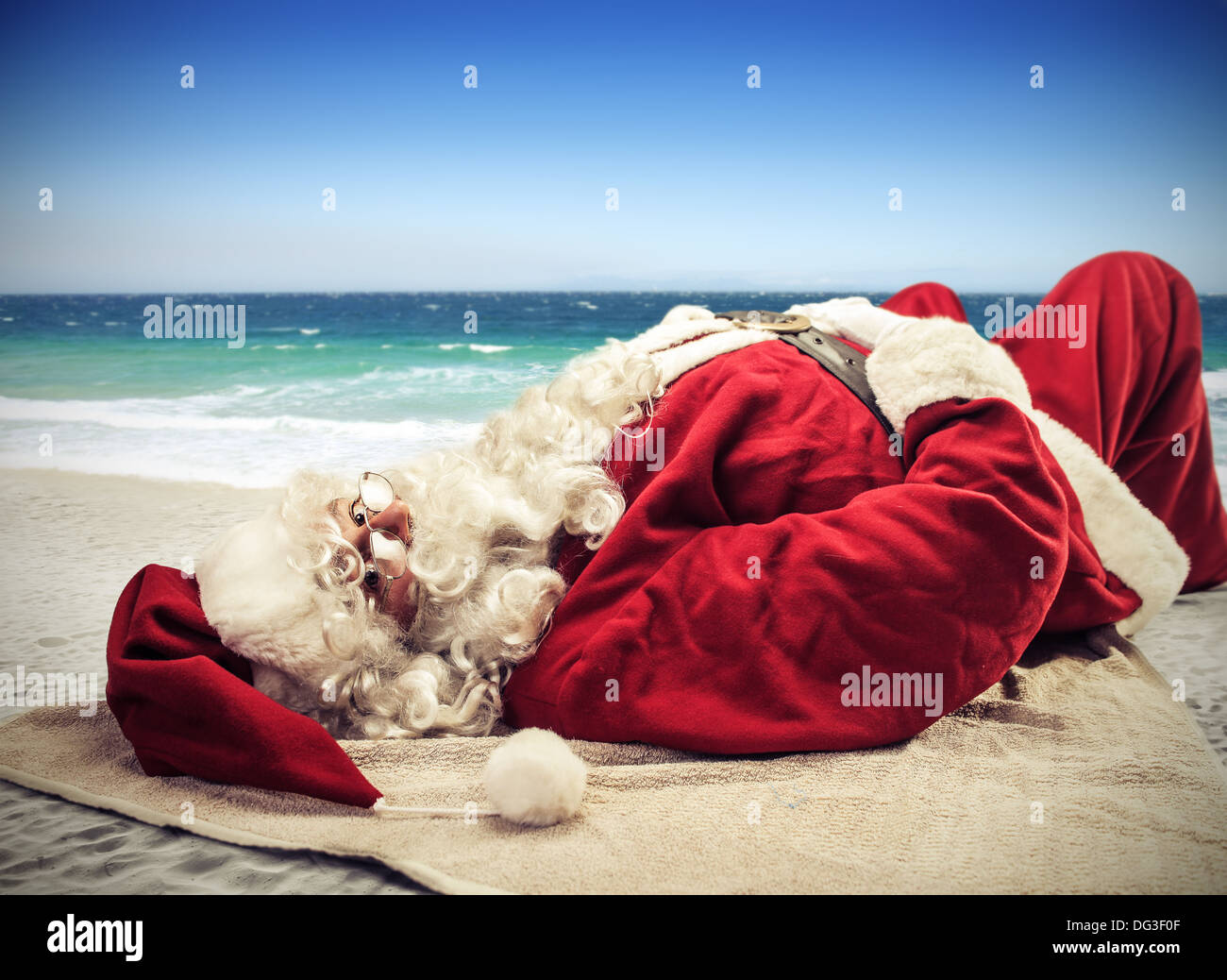 Santa Claus relaxing on a beach Stock Photo - Alamy